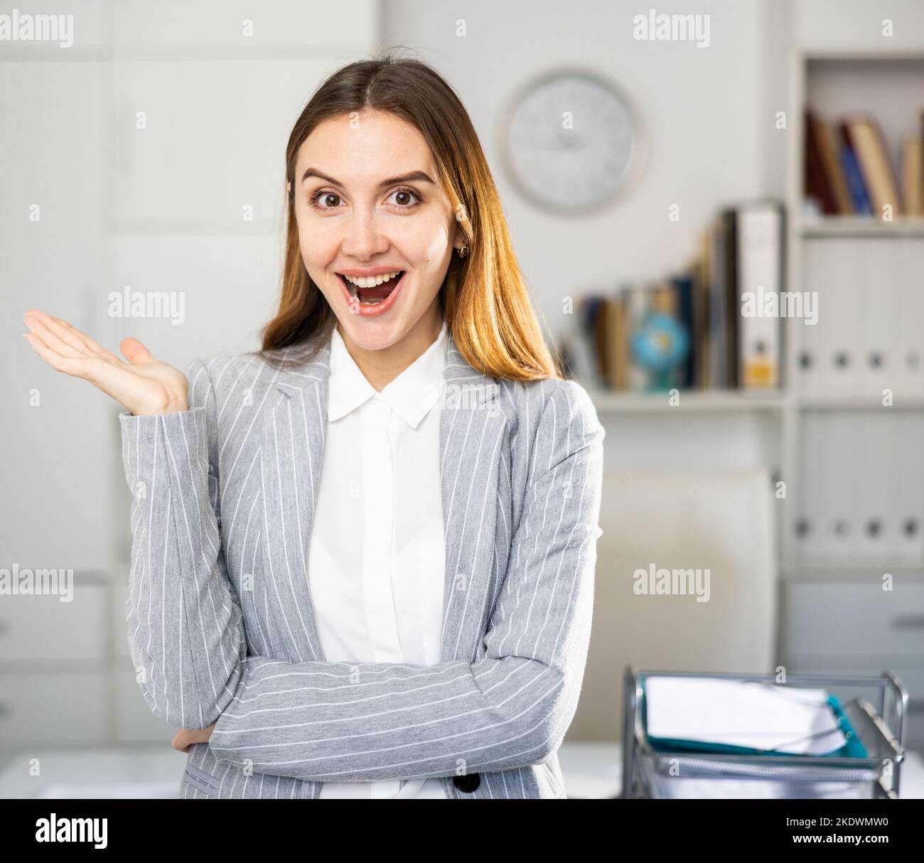 Business woman standing in office and pointing Stock Photo - Alamy