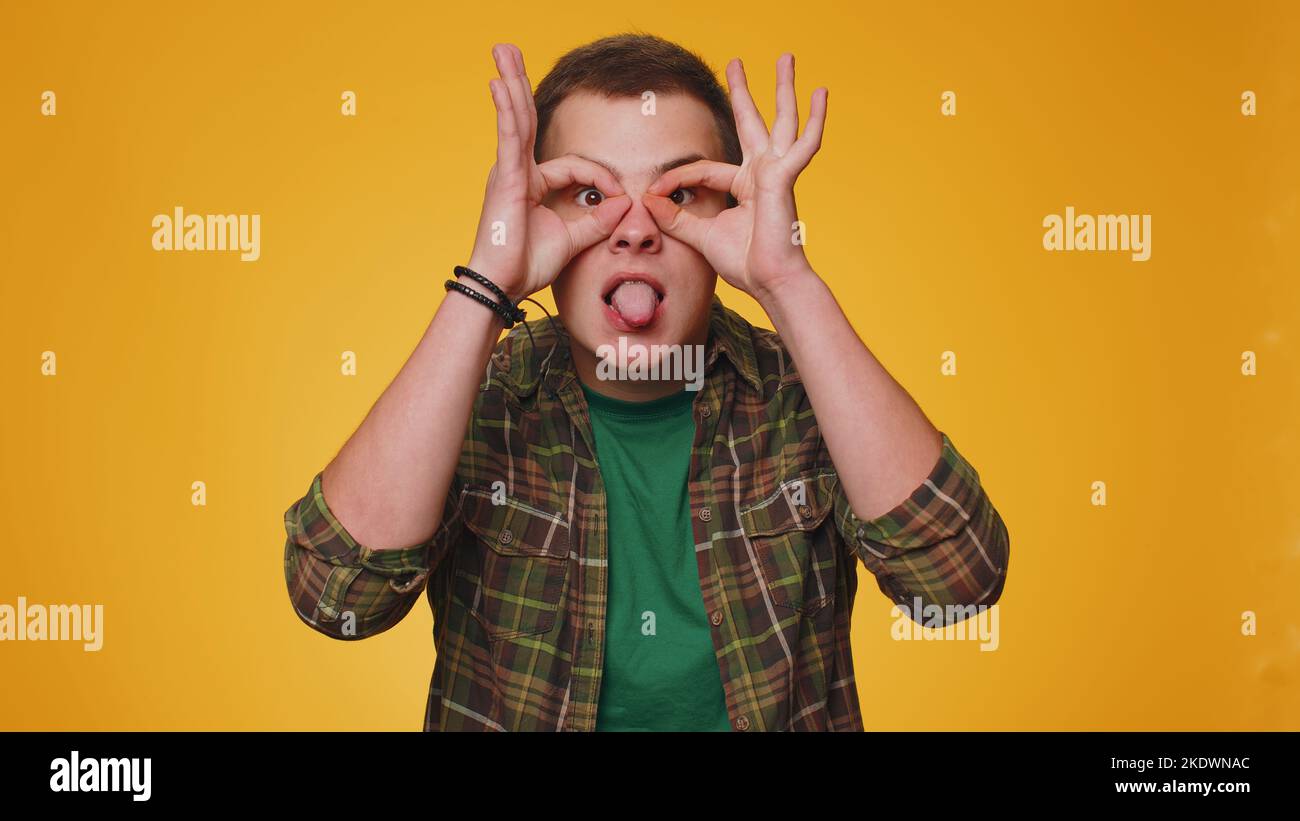 Funny joyful sincere adult man 20 years old in shirt making playful ...