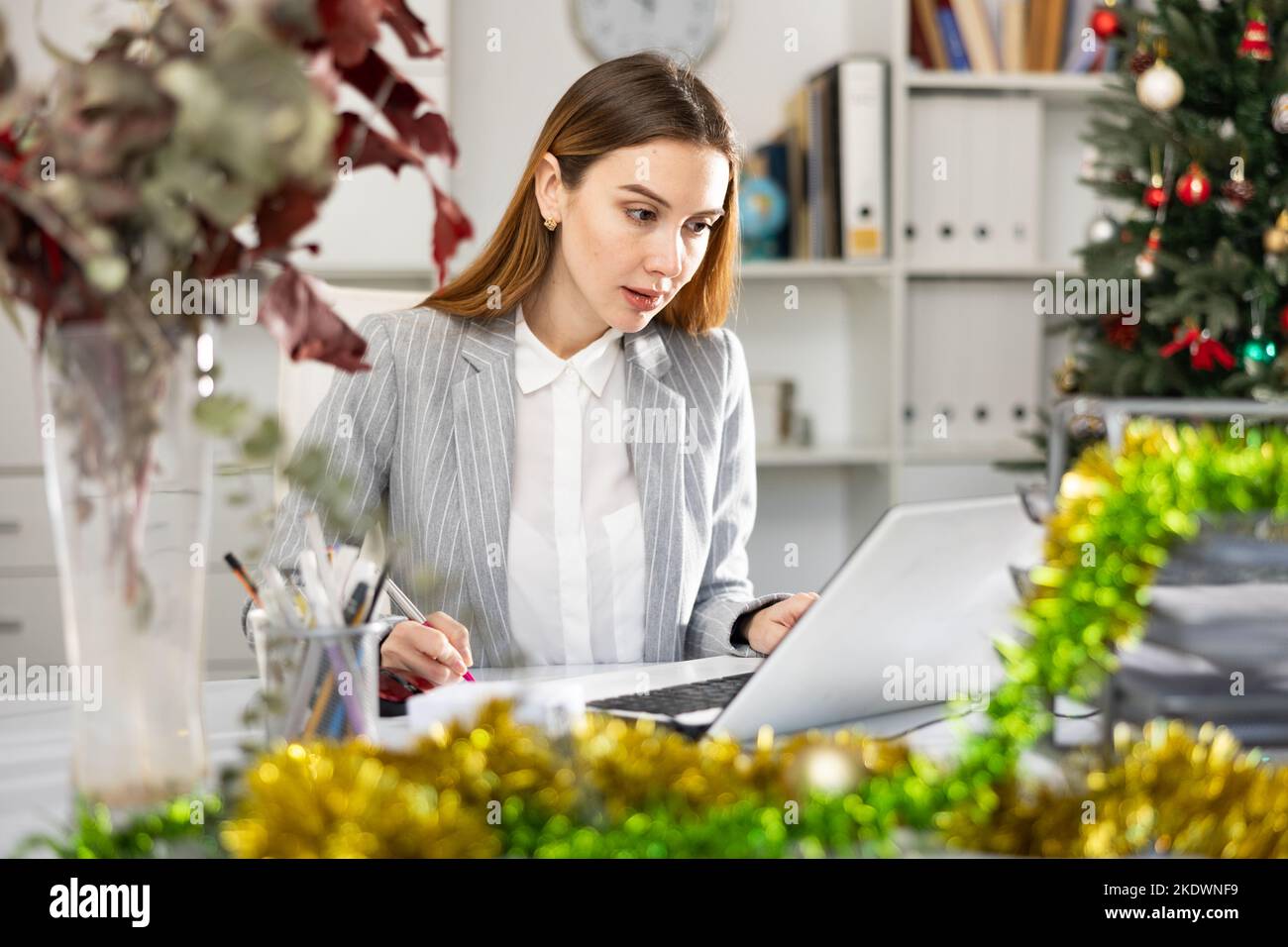 Businesswoman doing her daily work in office during Christmastime Stock ...