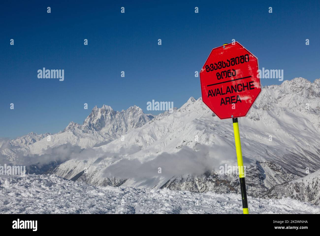 An Avalanche terrain near a mountain slope. The inscription on the red ...