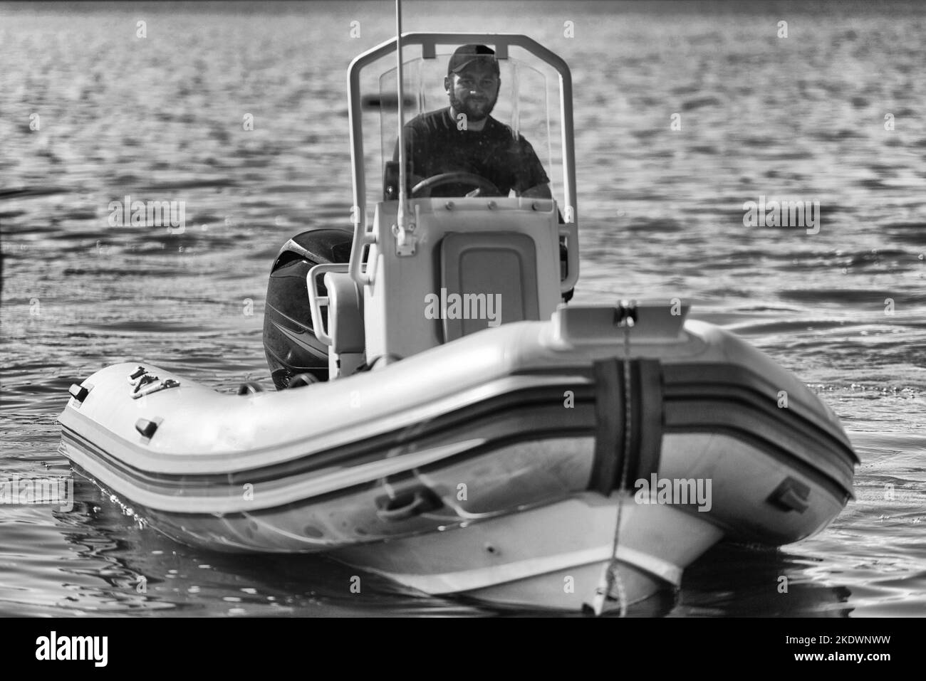 Rescuer in Protective Uniform on a Speedboat Observe the Ocean to ...