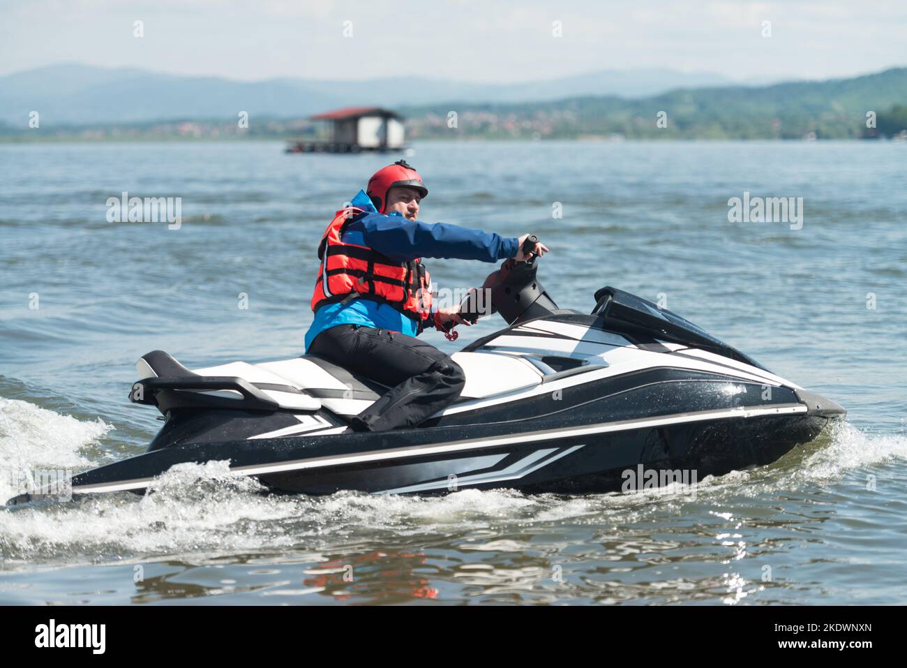 Rescuer Wearing Life Jacket in Protective Uniform on a Jet Ski Observe ...