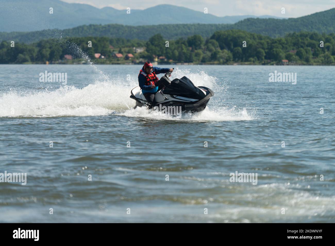 Rescuer Wearing Life Jacket in Protective Uniform on a Jet Ski Observe ...