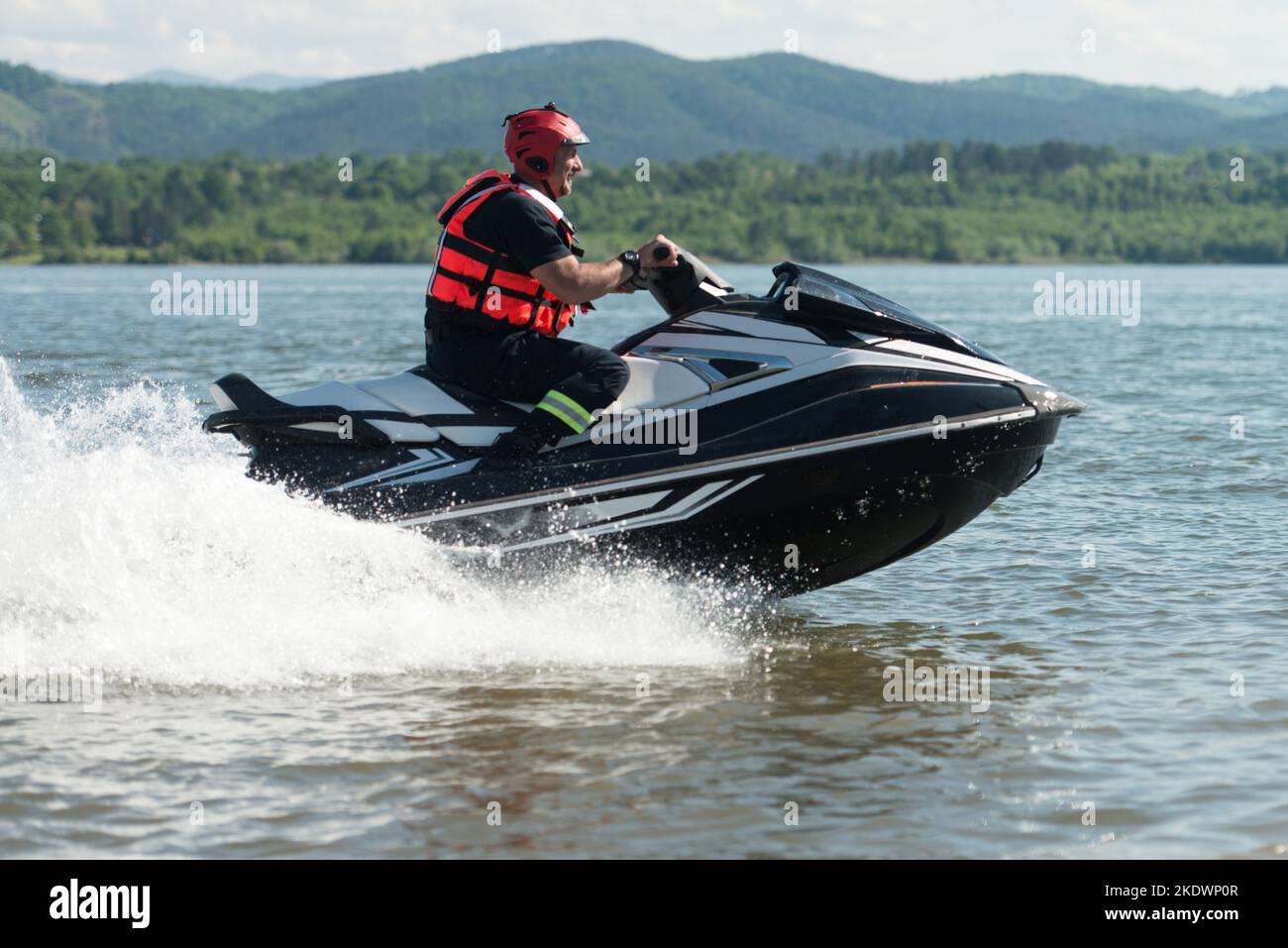 Male Rescuer in Protective Uniform Wearing Life Jacket on a Jet Ski ...