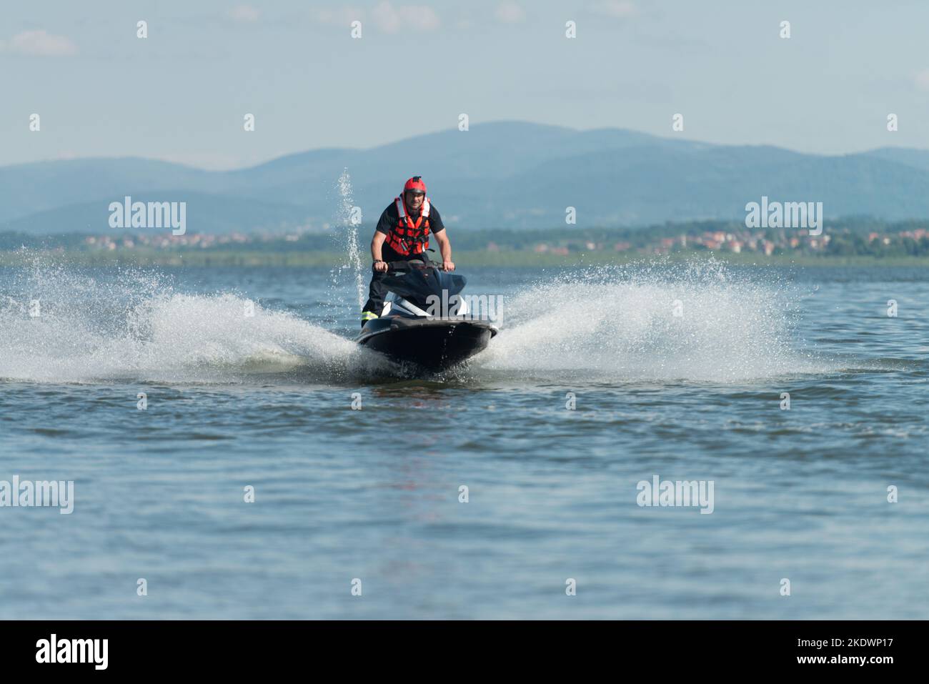 Male Rescuer in Protective Uniform Wearing Life Jacket on a Jet Ski ...