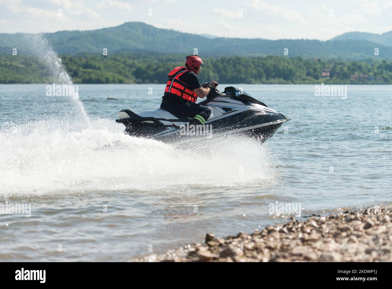 Rescuer Wearing Life Jacket in Protective Uniform on a Jet Ski Observe ...