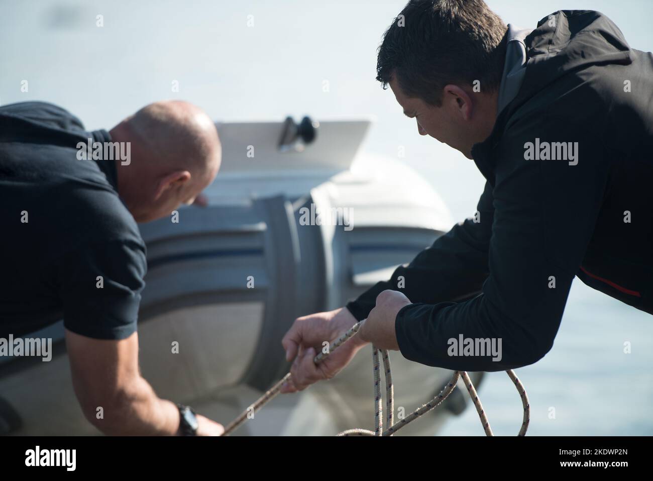 Rescuer in Protective Uniform Docking a Boat Speedboat after Observe ...