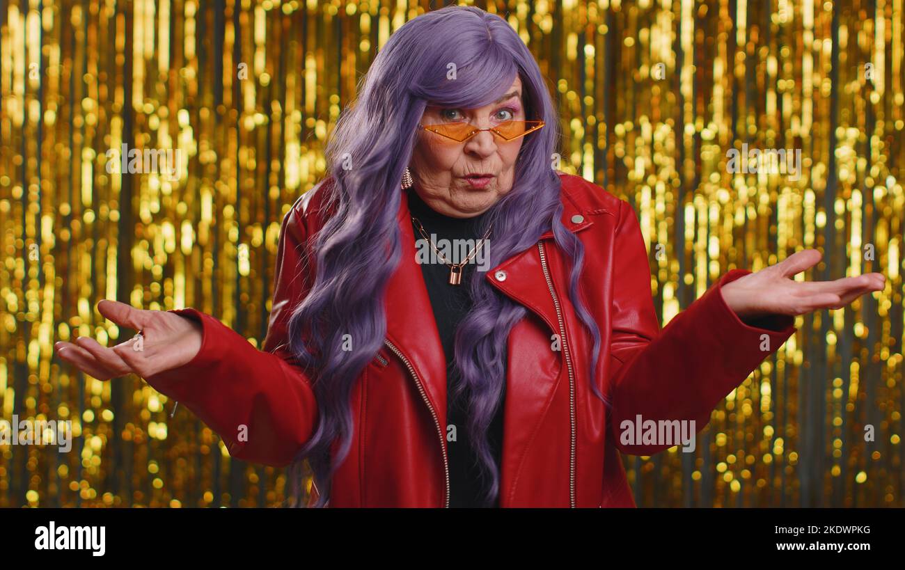 What Why. Sincere irritated elderly woman raising hands in indignant ...