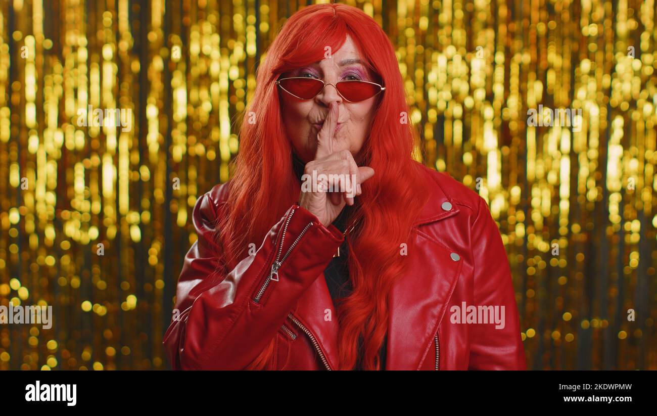 Shh be quiet please. Stylish mature woman 70 years old presses index ...