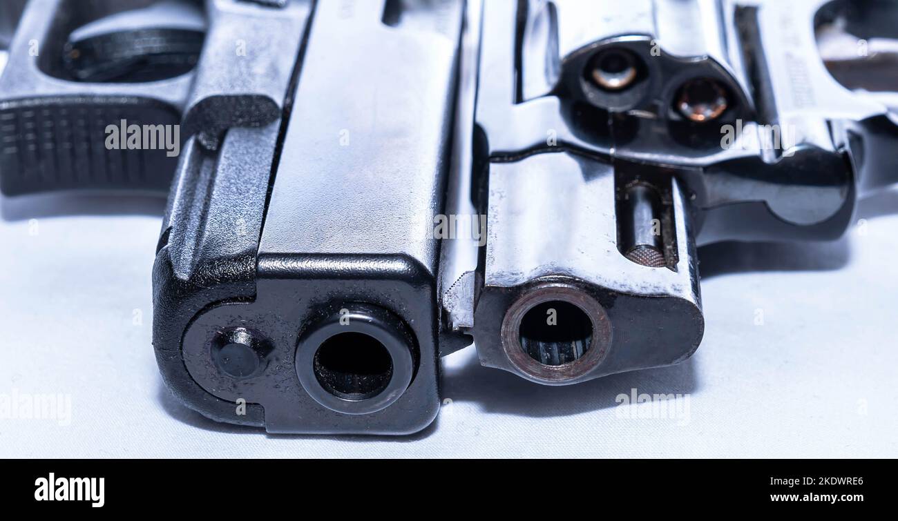 Two handguns, a black 9mm pistol and a black 38 caliber snub nose ...