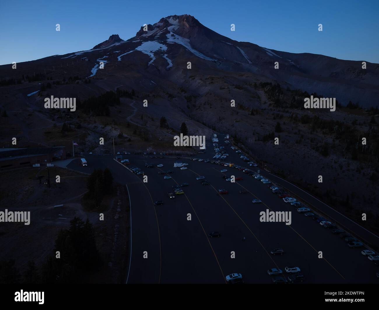 Car parking near the mountain range. Large paved area, many cars ...