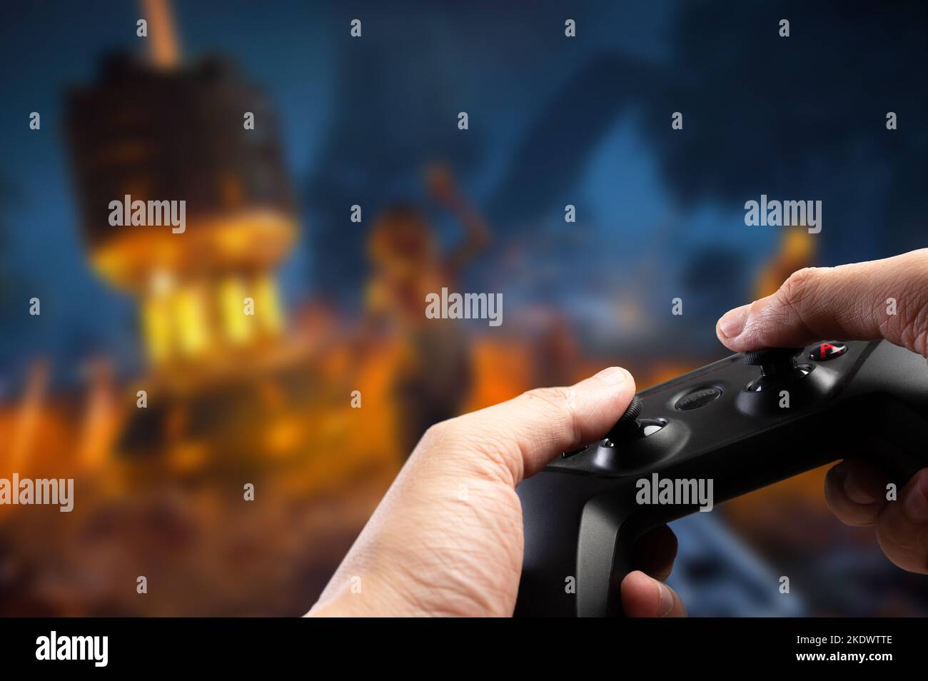 Against the backdrop of a video game on a large screen of a plasma TV ...