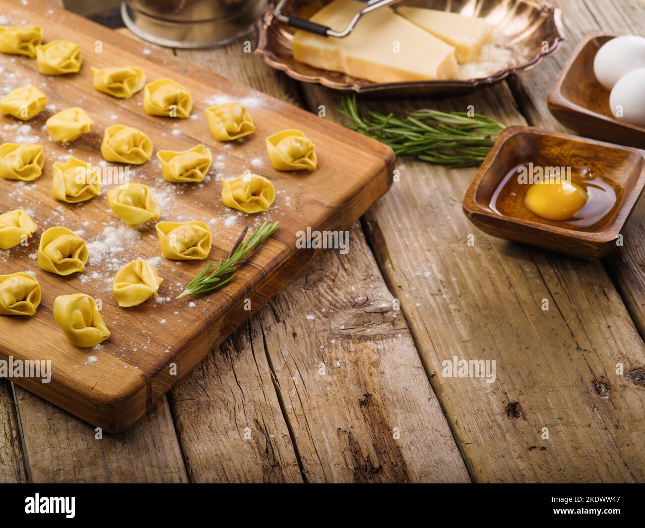 The process of making homemade dumplings, ravioli. On a wooden table ...