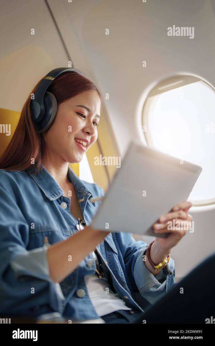 Female passenger using tablet hi-res stock photography and images - Alamy