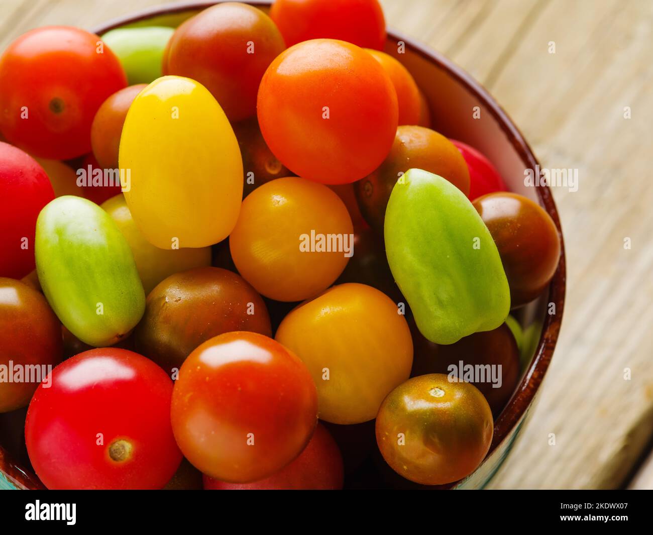 Close-up. Bright colorful tomatoes in a bowl. Beautiful culinary ...