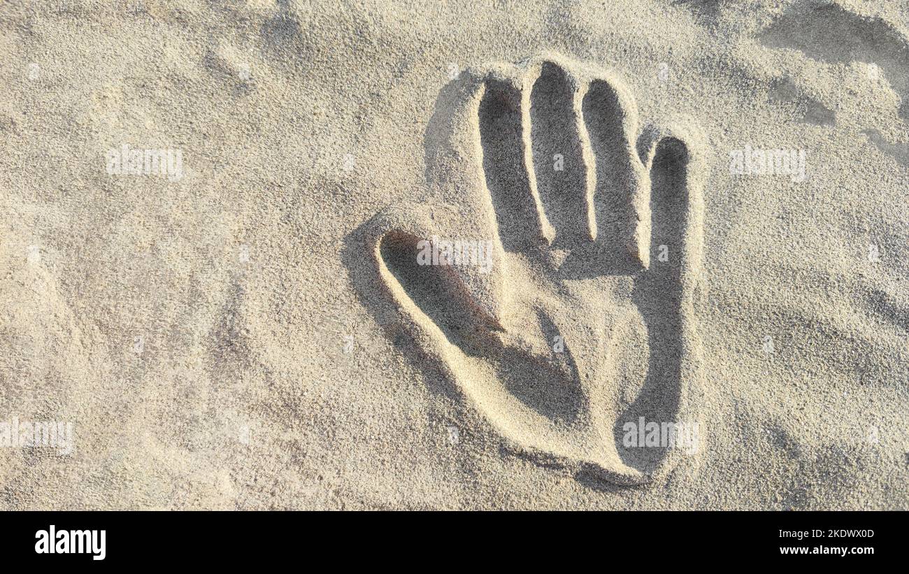 Background of handprint in sand, copy space. Top view, close-up Stock ...