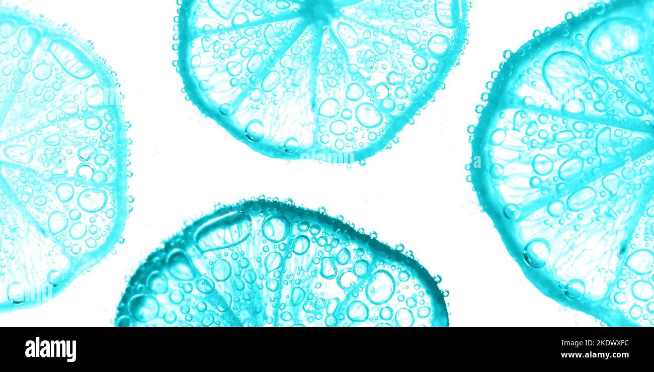 Juicy lemon slices with bubbles under water isolated on white ...