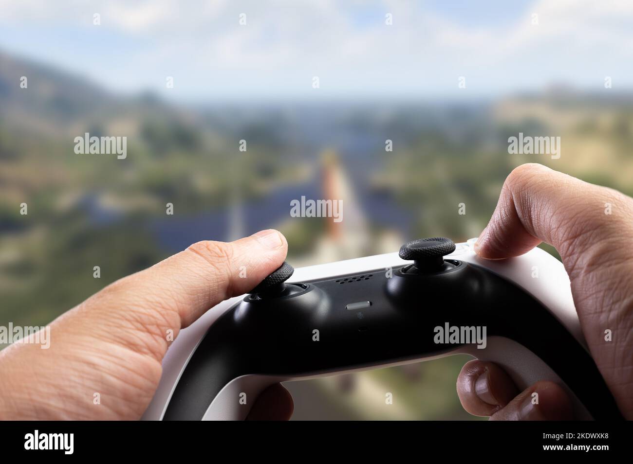 A modern GAM22ICB gamepad in the hands of a gamer against the backdrop ...