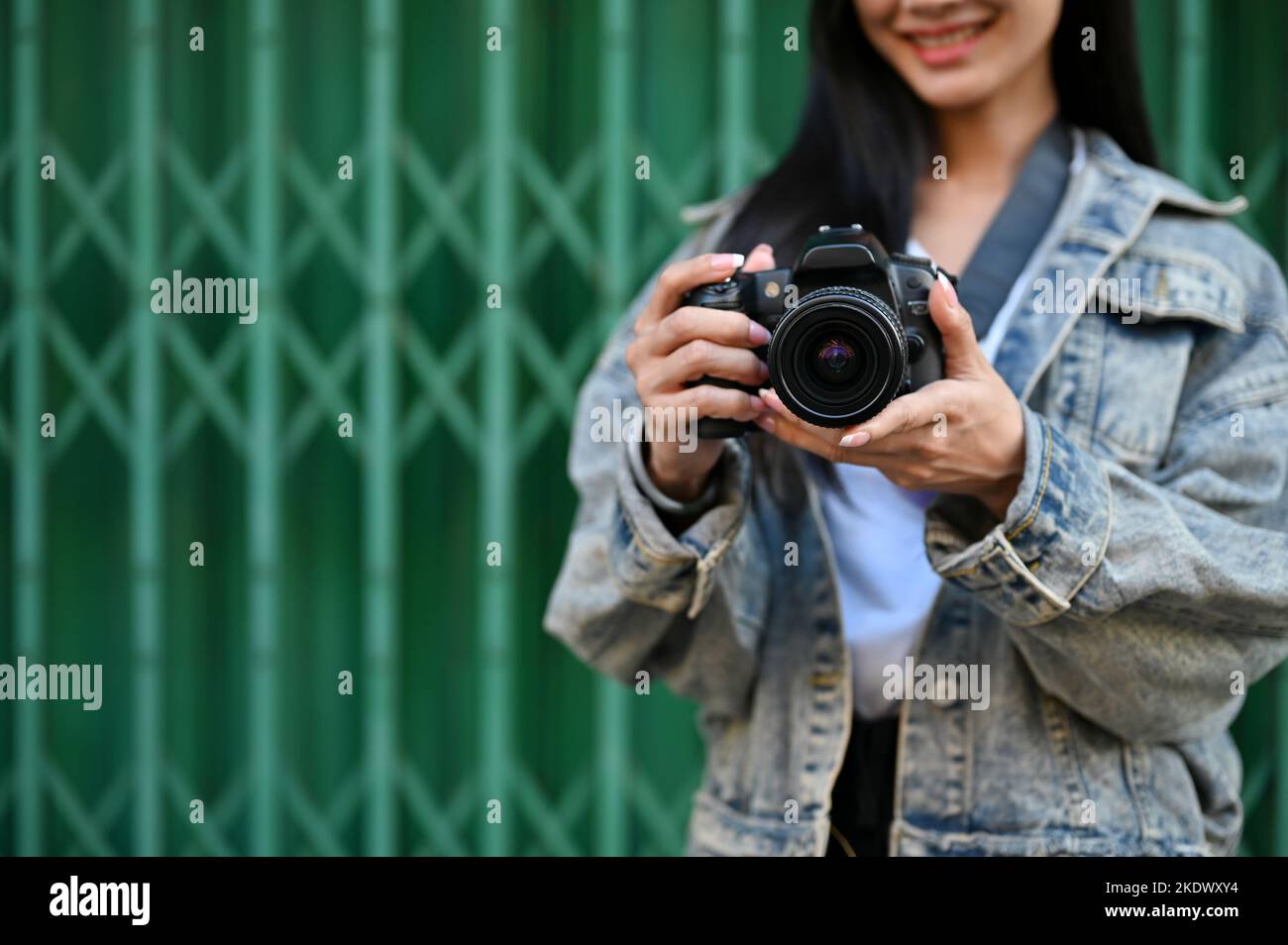 Close up view of young woman holding her camera ready to take a photo ...
