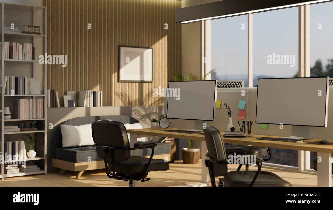 Modern study room with blank screen PC desktop computers on wooden ...