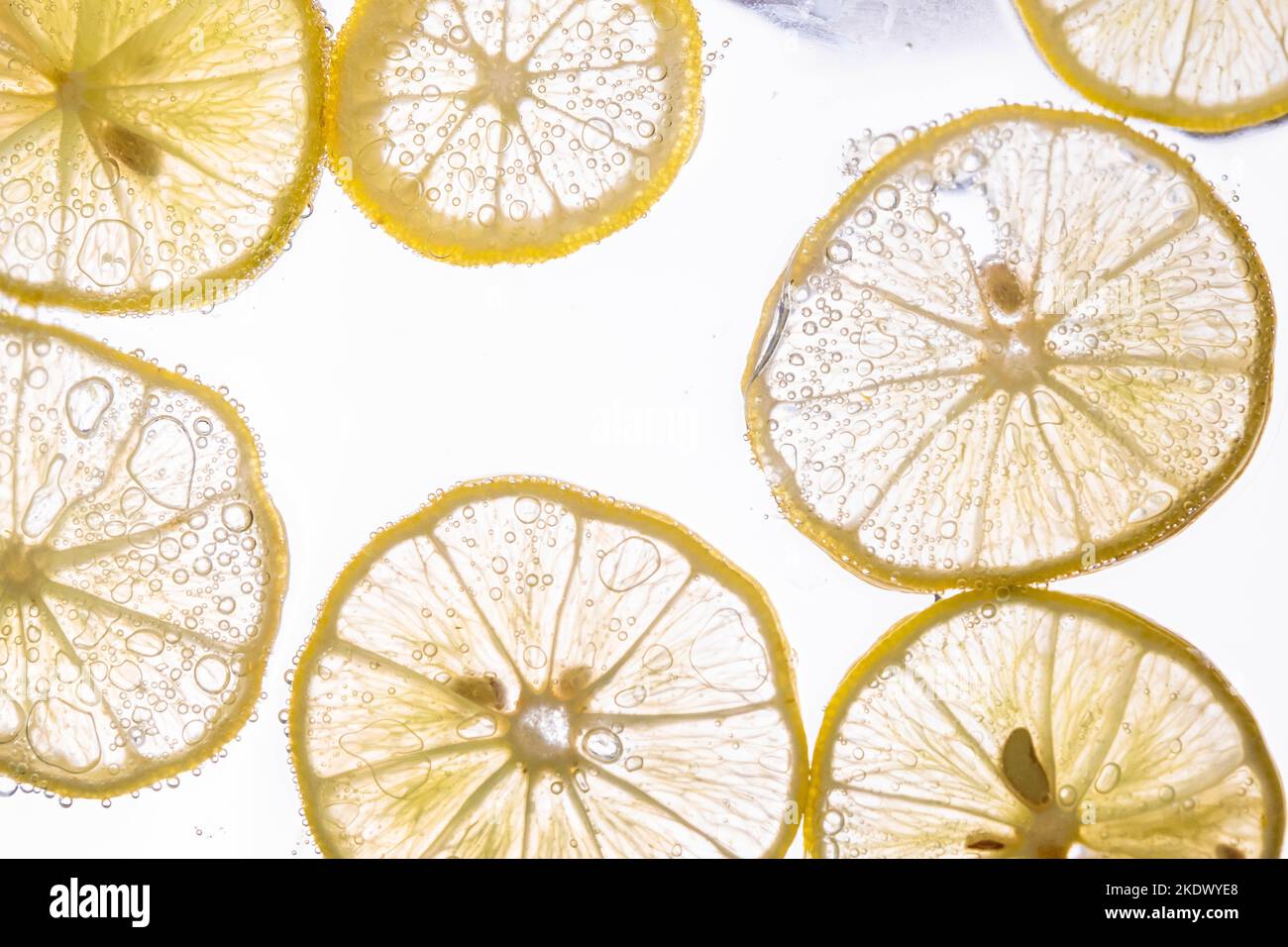 Juicy lemon slices with bubbles under water isolated on white ...