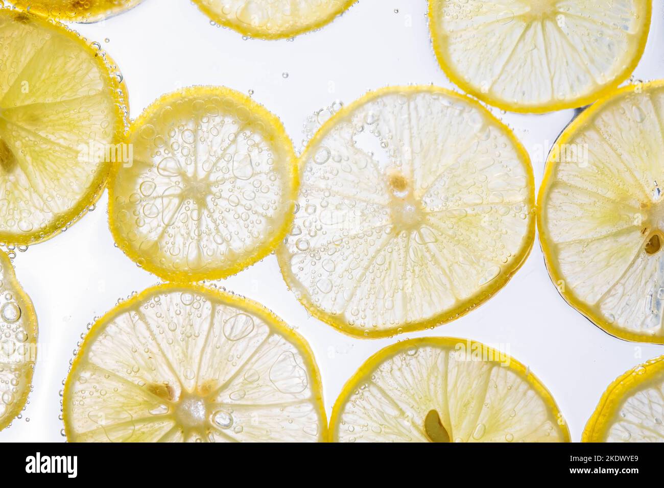 Juicy lemon slices with bubbles under water isolated on white ...