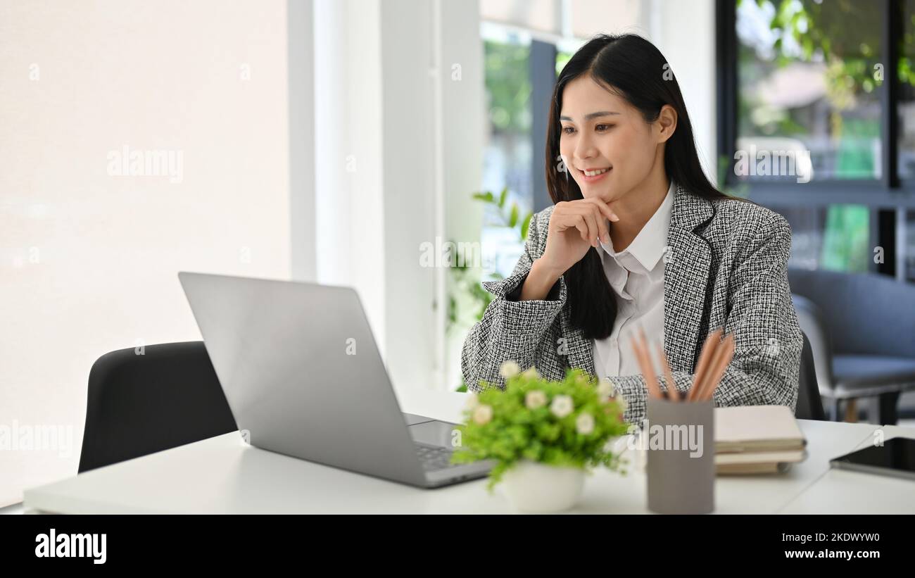 Charming and successful millennial Asian businesswoman or female CEO in ...