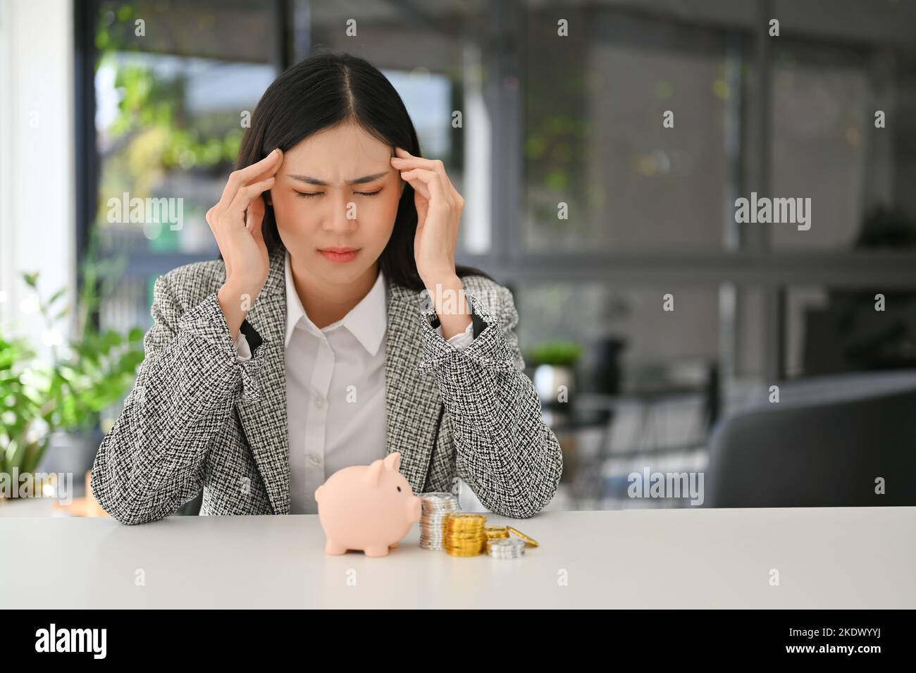 Stressed and frustrated Asian businesswoman having a problem with her ...