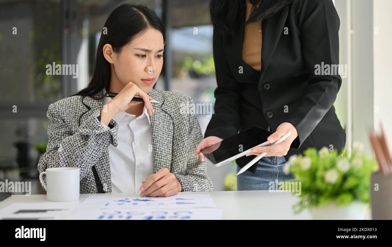 Professional and stressed millennial Asian businesswoman or female ...