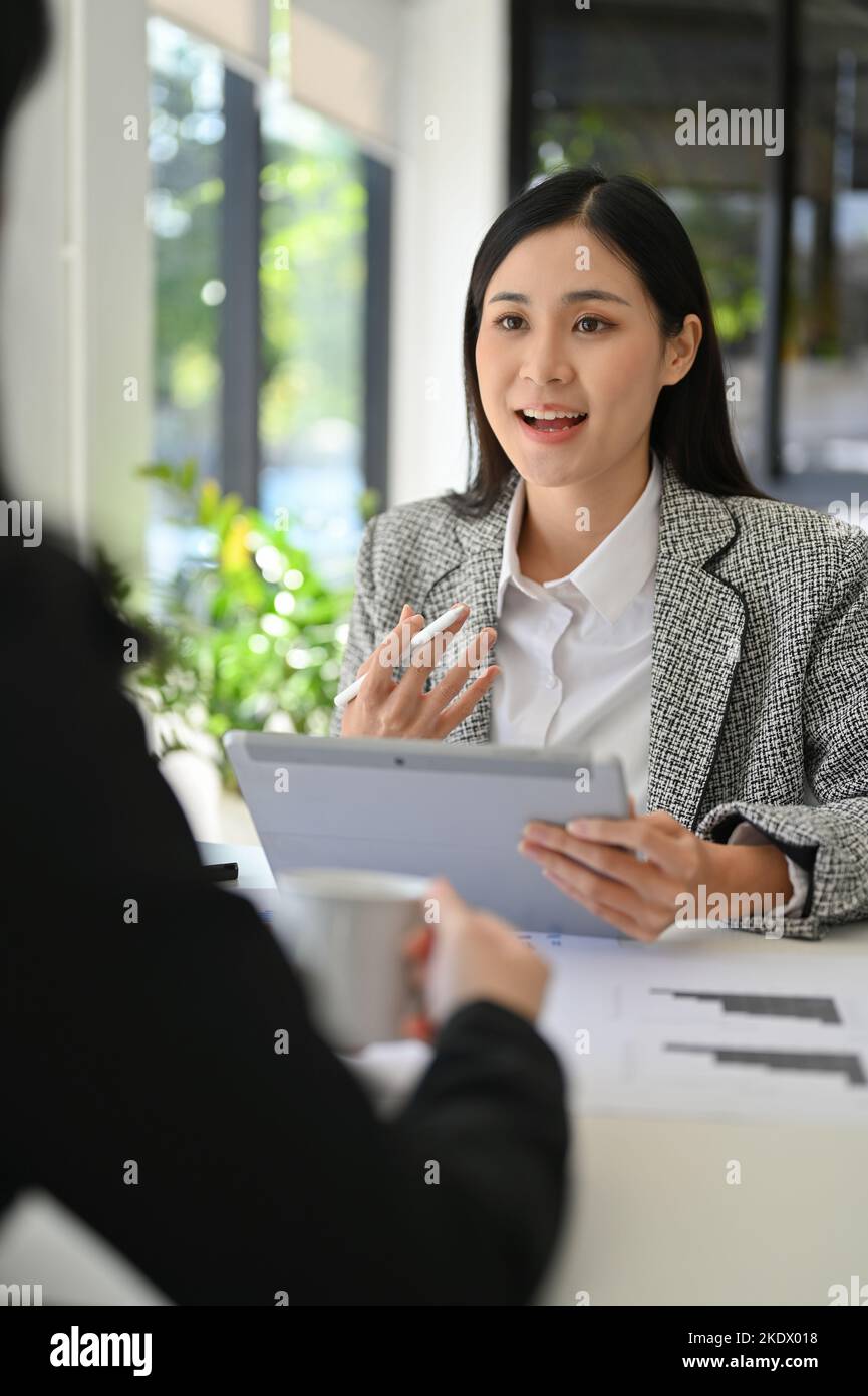 Attractive and charming young Asian businesswoman or female marketing ...