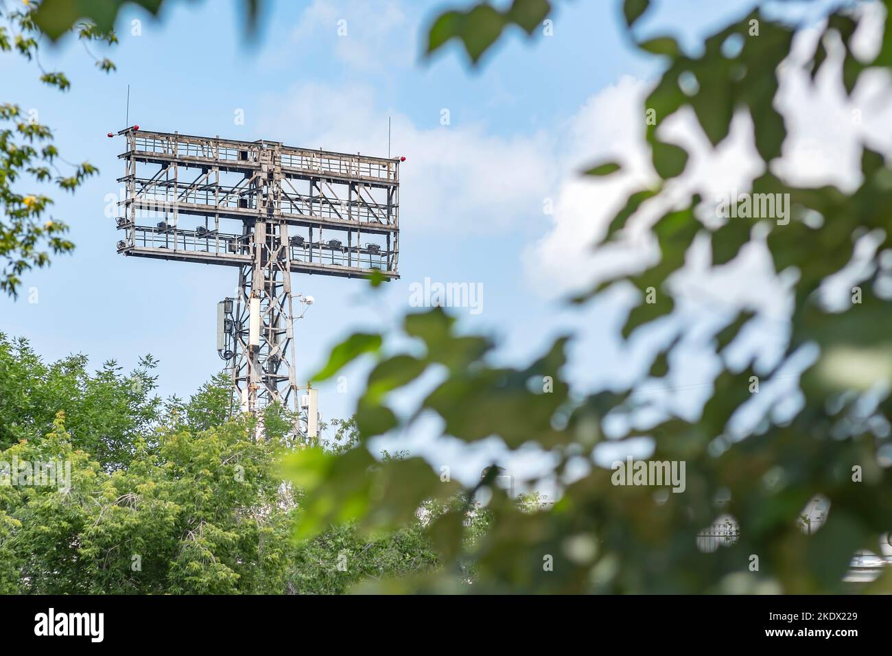 large lighting tower for a street stadium, a football field with large ...