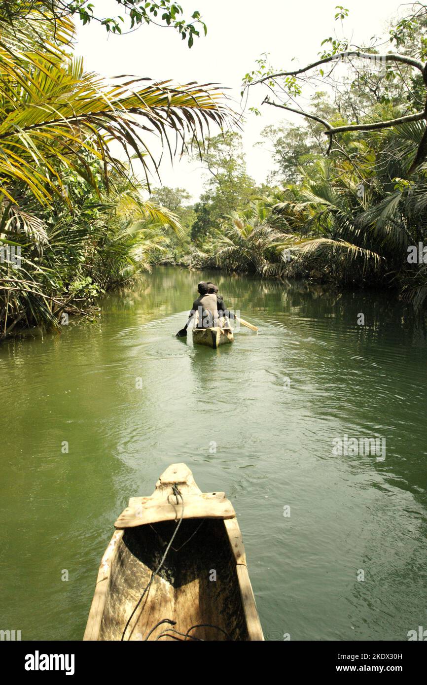 National park rangers travelling by boat on Cigenter river through the ...