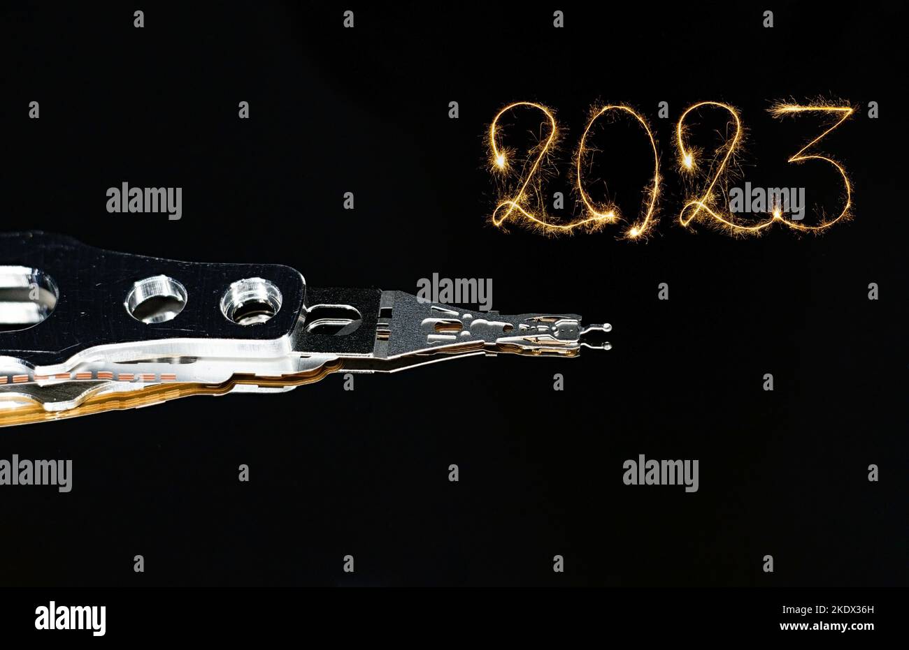 2023 numbers written with sparklers sparks font on a Hard disk with a ...