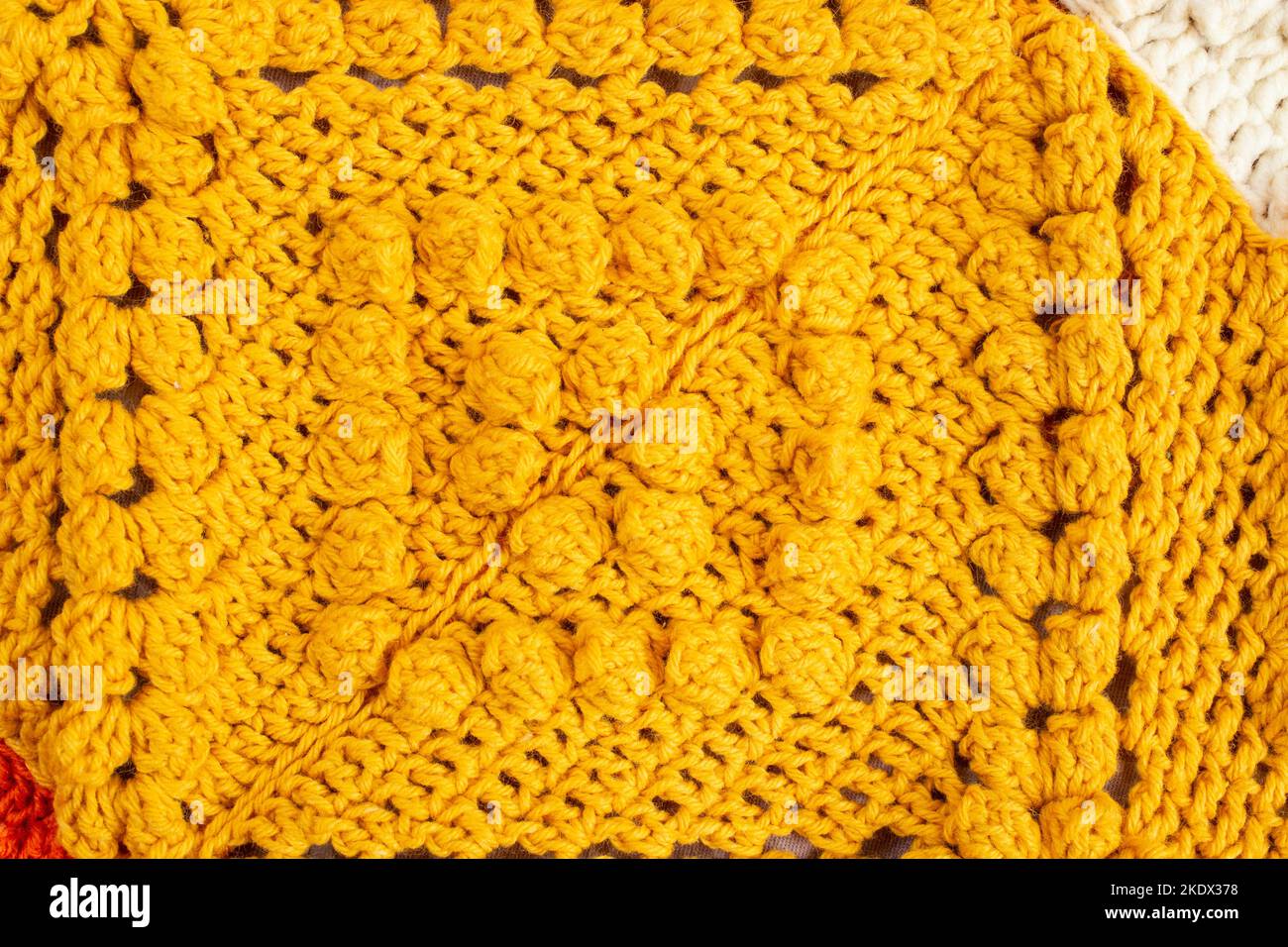 crochet pattern with bubble stich yellow colored thread Stock Photo - Alamy