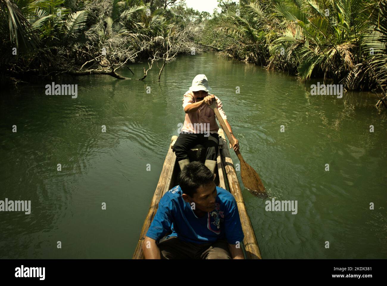 National park rangers travelling by boat through Cigenter river in ...