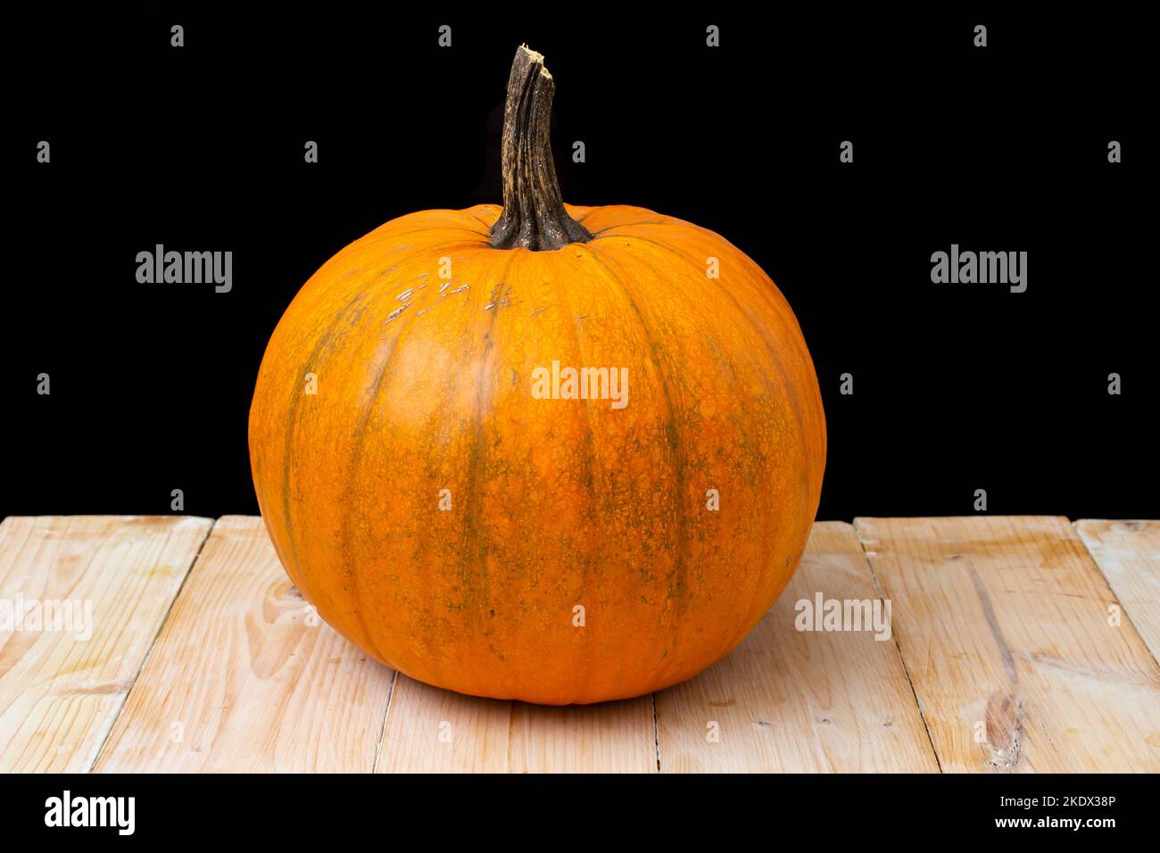 Orange pumpkin on woodboards table, with black background Stock Photo ...