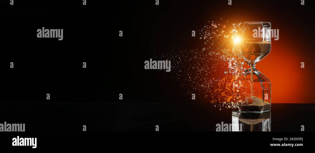 Disappearing hourglass on dark background with space for text Stock ...