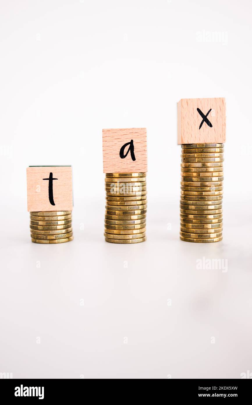 Tax text on top of growing stacks of coins, symbol of increasing tax ...