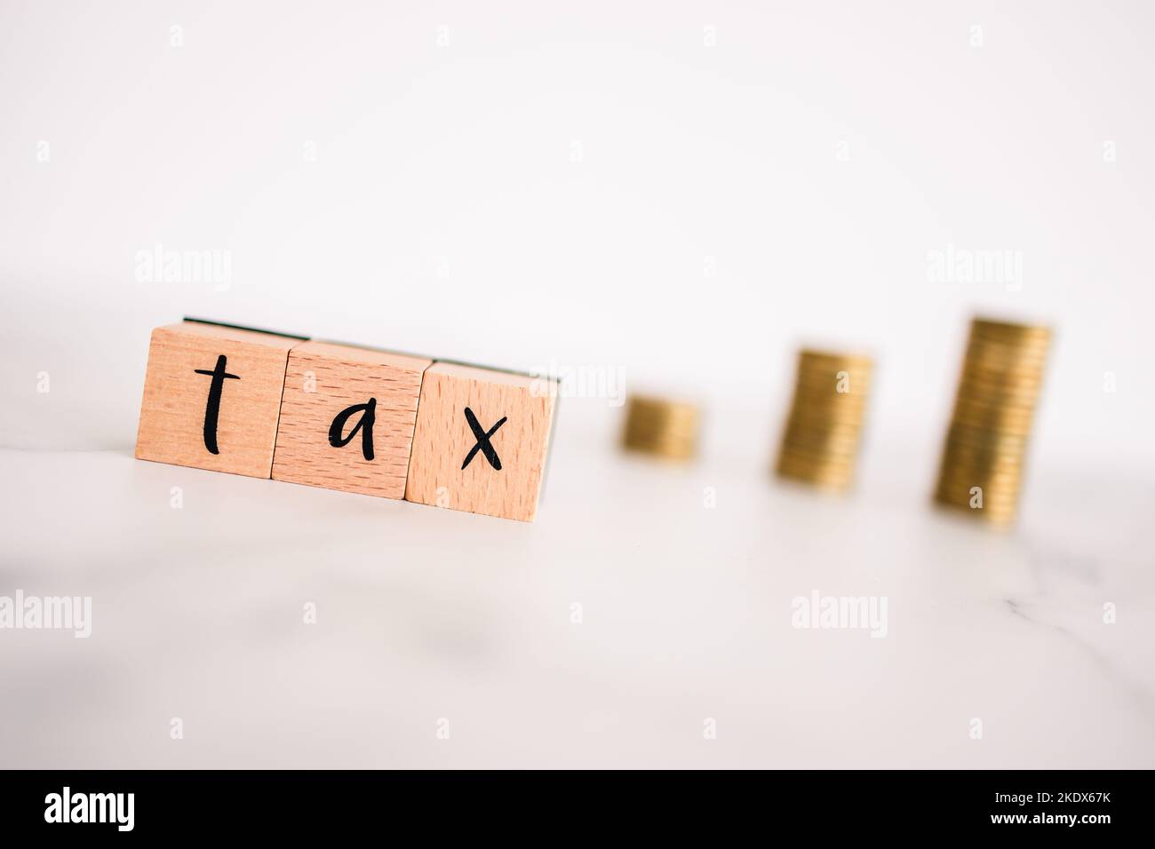 Tax text on top of growing stacks of coins, symbol of increasing tax ...