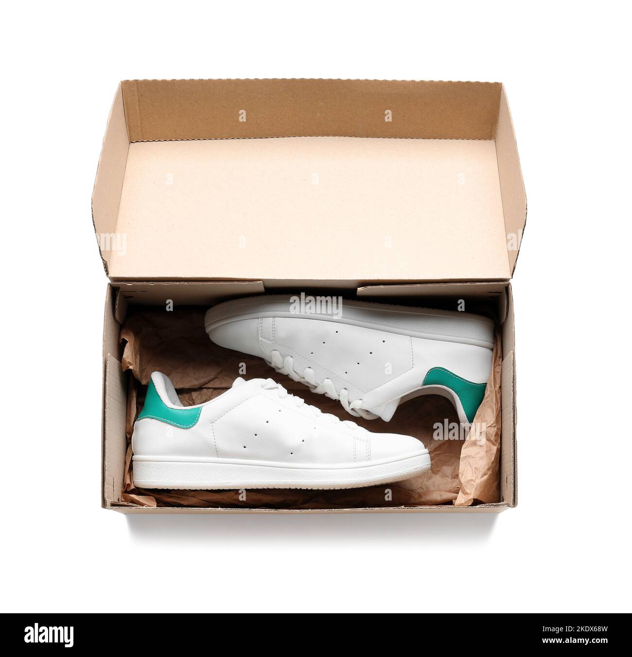 Cardboard box with sneakers on white background Stock Photo - Alamy