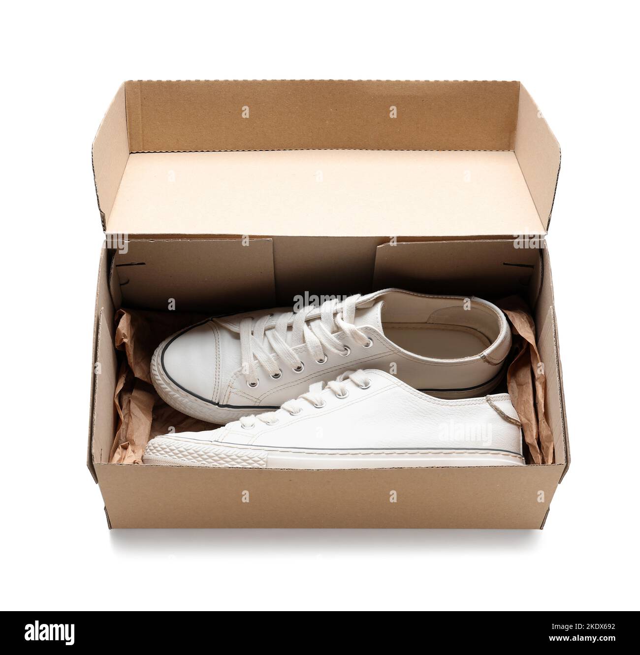 Cardboard box with sneakers on white background Stock Photo - Alamy