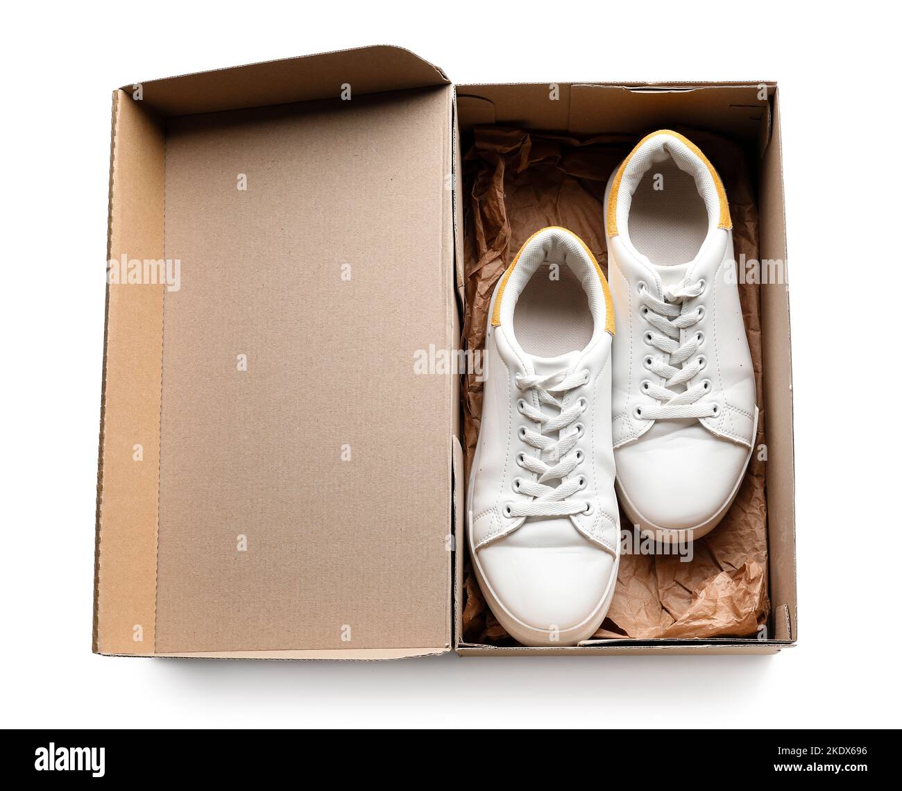 Cardboard box with sneakers on white background Stock Photo - Alamy