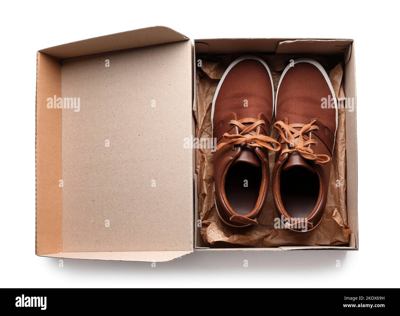 Cardboard box with brown male shoes on white background Stock Photo - Alamy