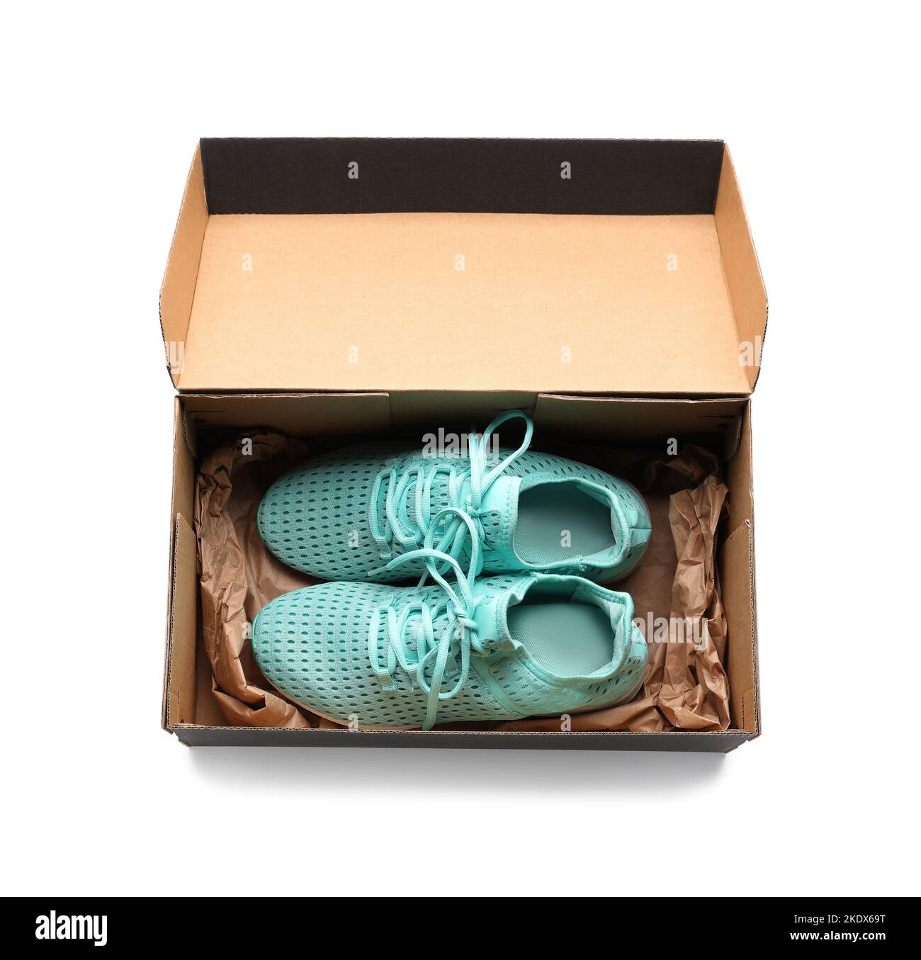 Cardboard box with blue running shoes on white background Stock Photo ...