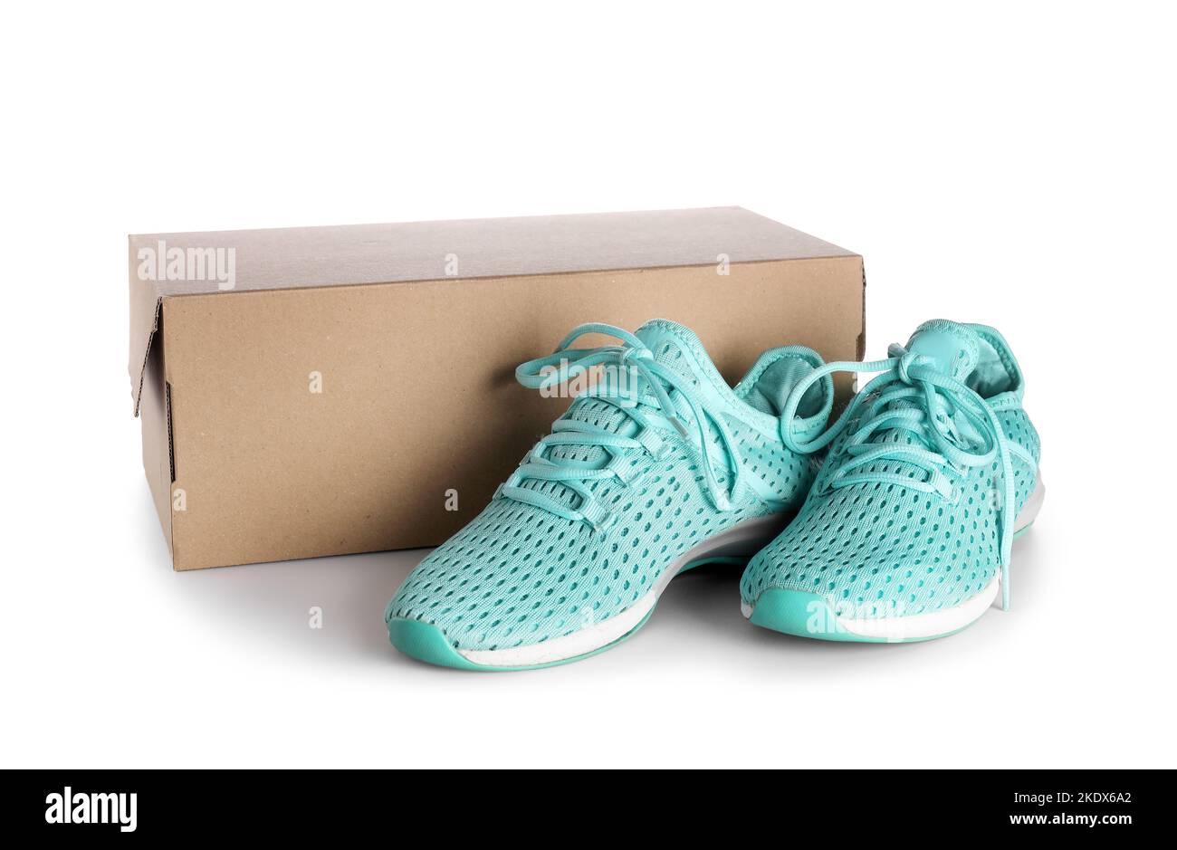 Cardboard box with blue running shoes on white background Stock Photo ...
