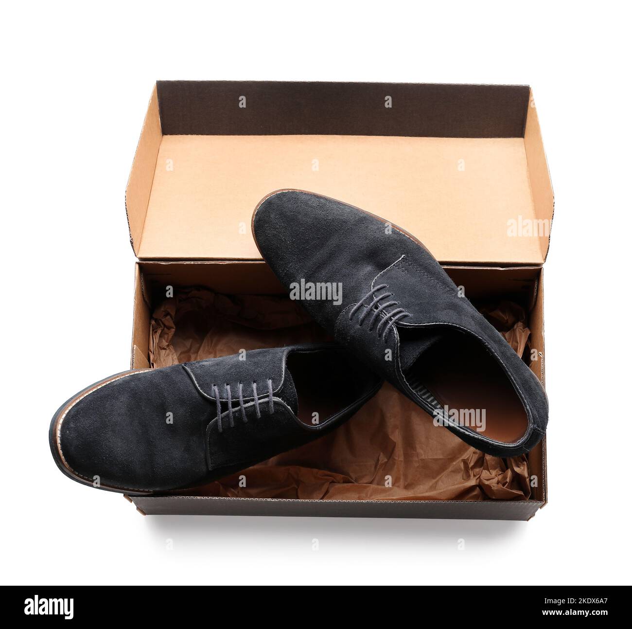 Cardboard box with black shoes on white background Stock Photo - Alamy
