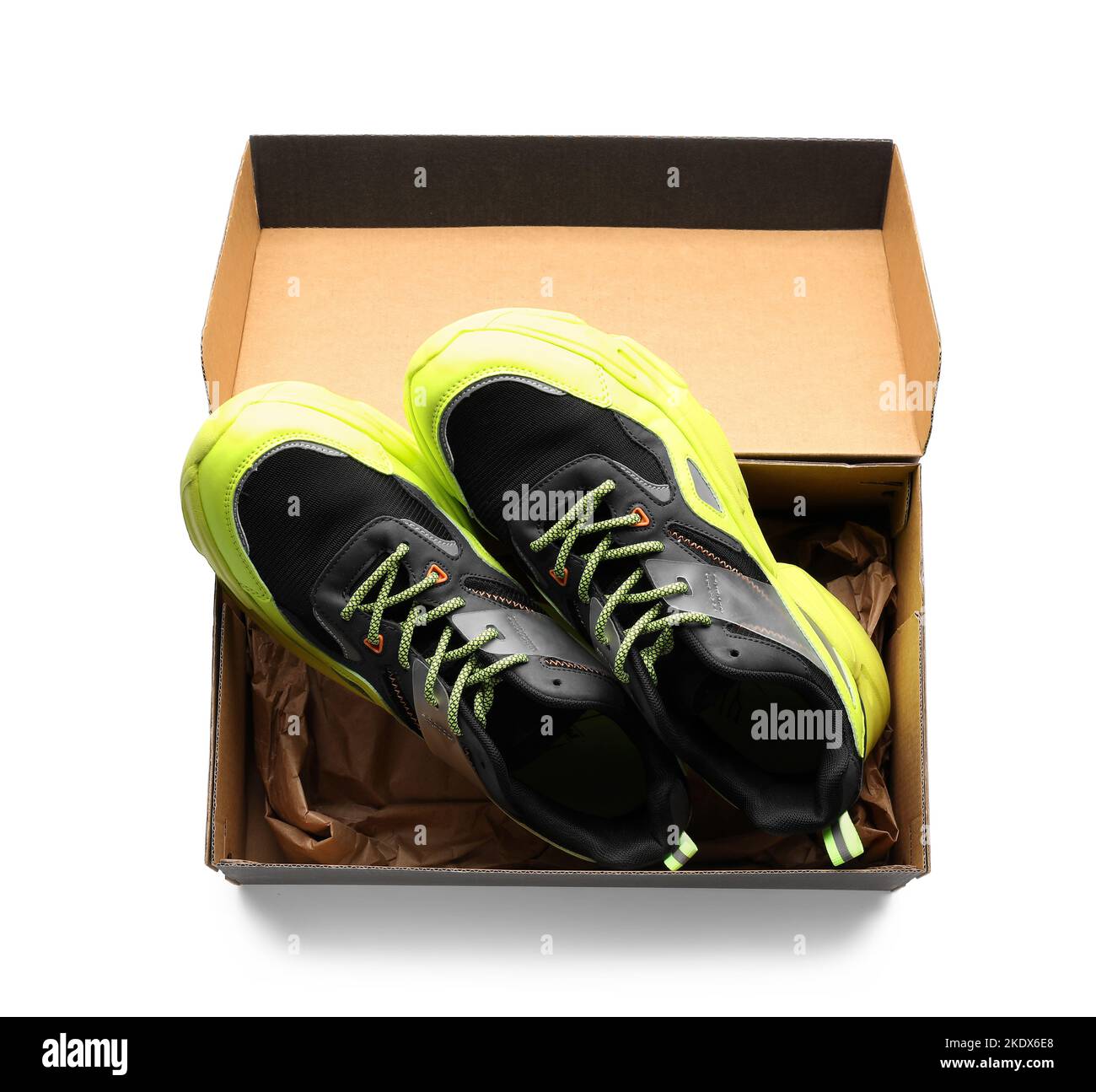 Cardboard box with black running shoes on white background Stock Photo ...