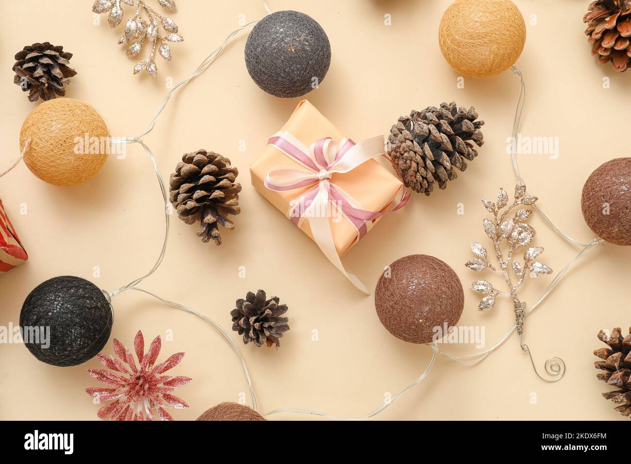 Gift with Christmas decor and fir cones on beige background Stock Photo ...