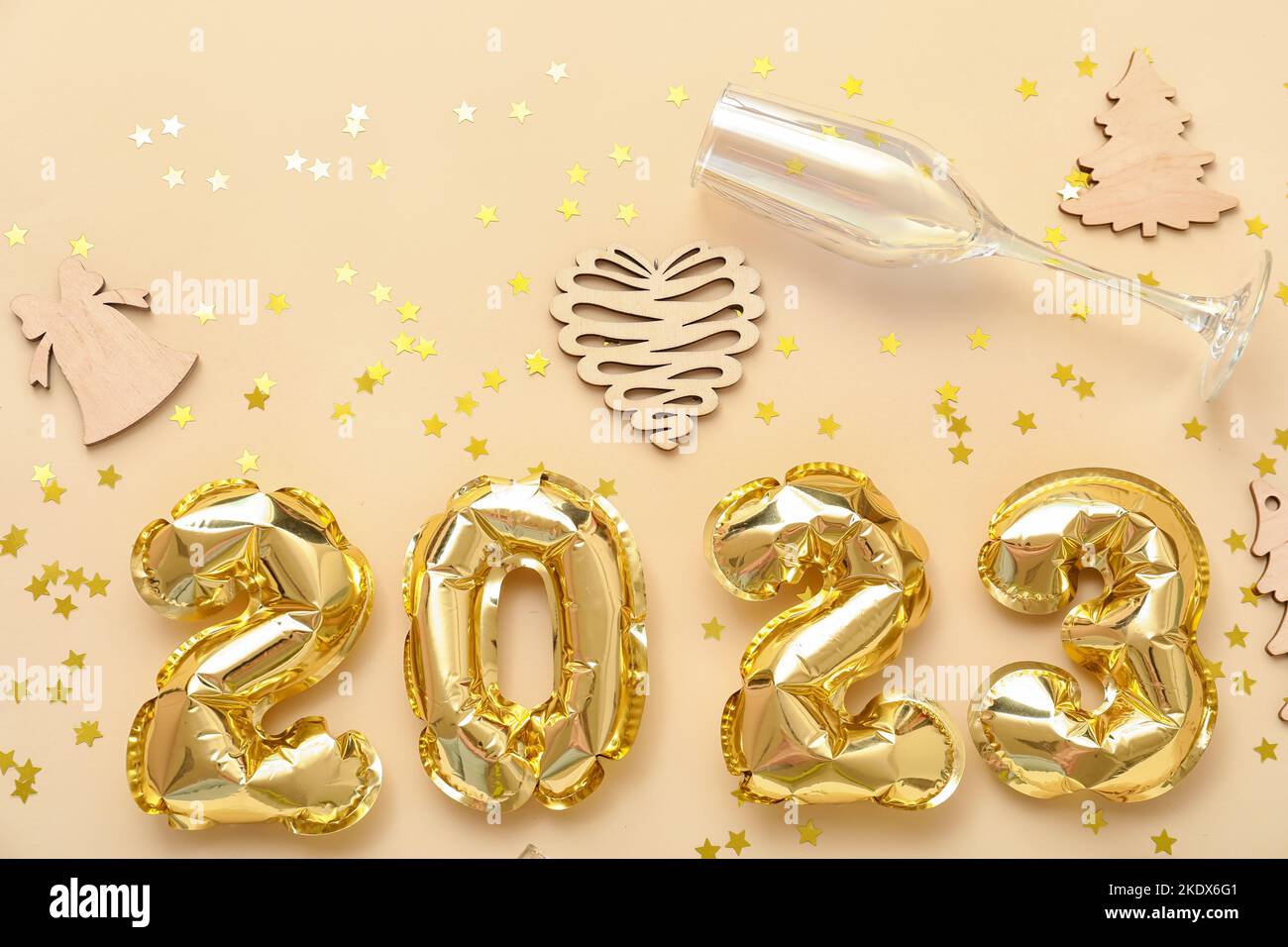 Figure 2023 made of balloons with Christmas decor and glass on beige ...