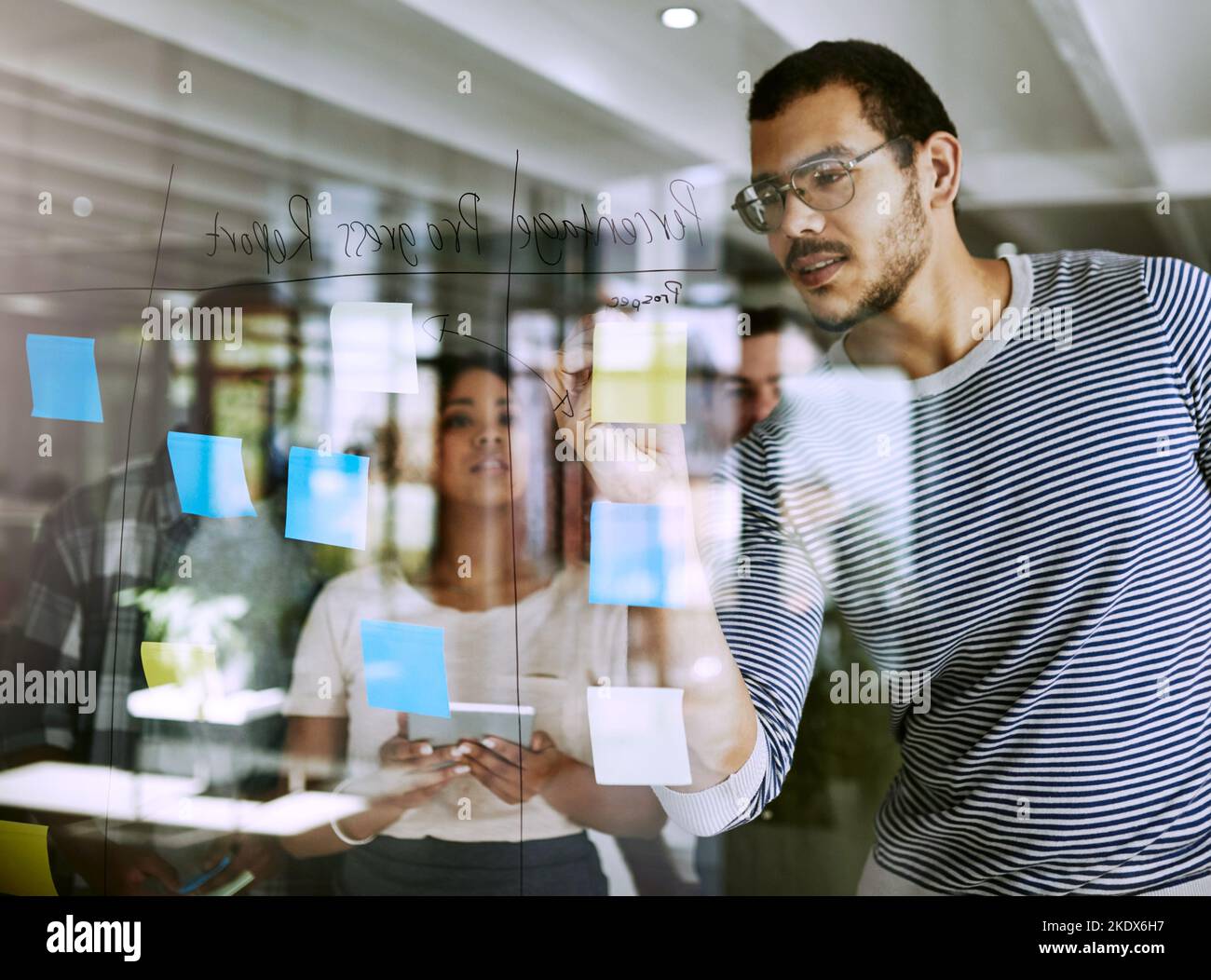 Hes leading the planning process. a group of young designers planning ...